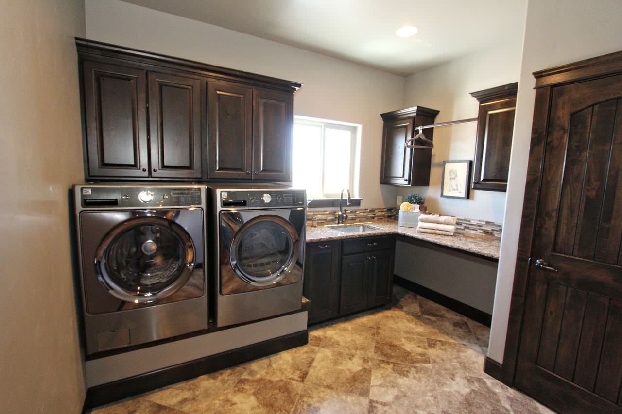 Enhance the laundry room with a pull-out hamper and linen closet ...